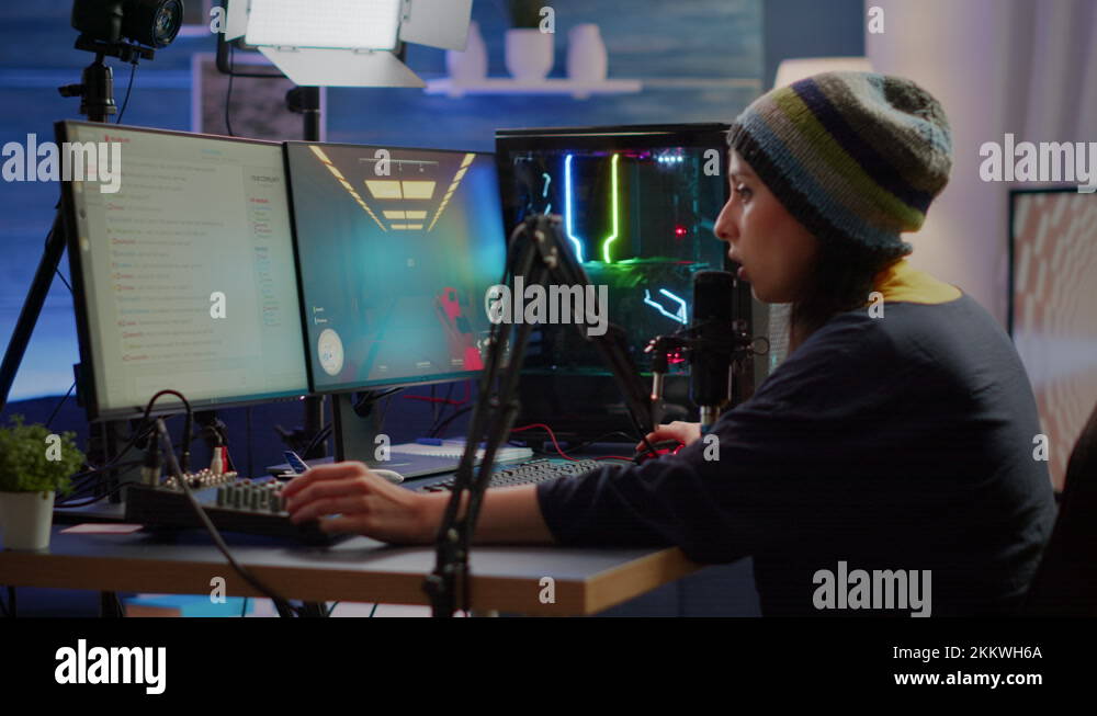Professional woman streamer playing FPS games talking into microphone ...