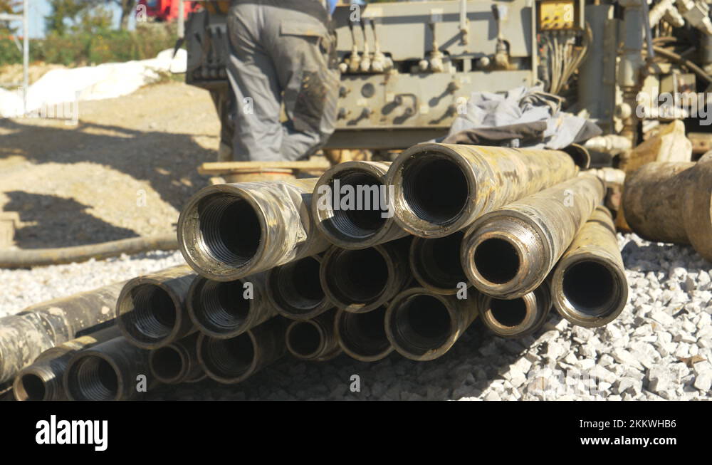 CLOSE UP: Detailed shot of metal pipes as contractor operates a drill ...