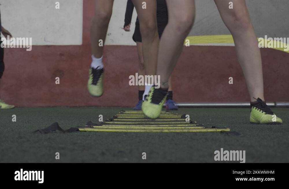 football players on a speed and agility training ladder rings in the ...