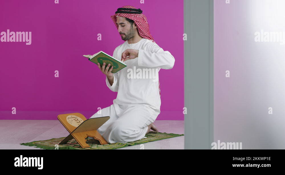 Arabian Muslim man in traditional clothes praying during a Ramadan ...