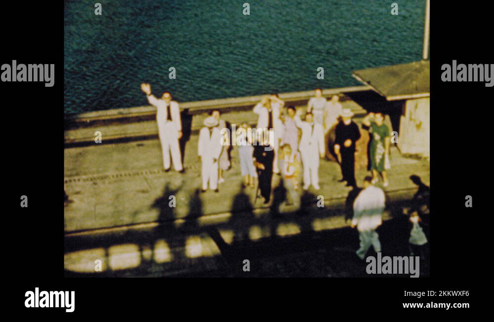 1950s: Workers walk across Panama Canal. People stand on dock, wave ...