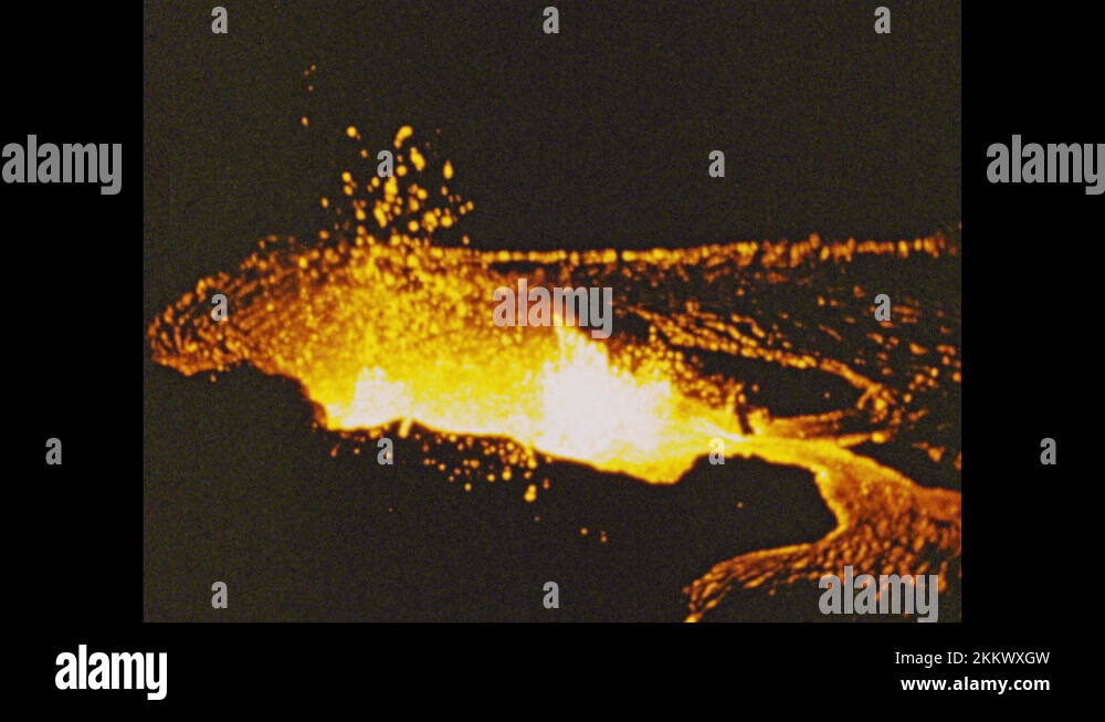 1950s: Volcano erupts, spilling lava. Hawaiian beach with waves and ...