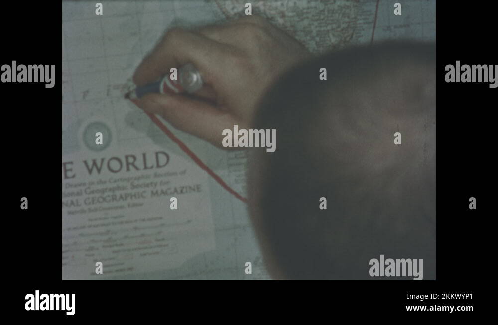 1960s: Man draws on map with red marker. Men at work in control room of ...