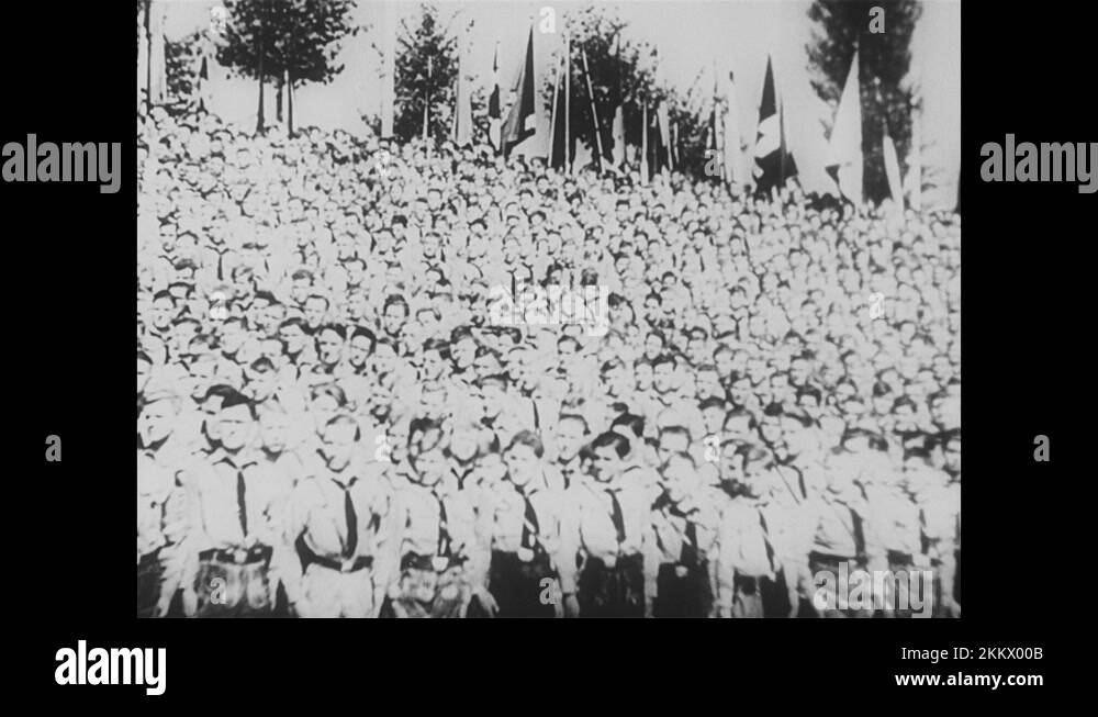 1930s Germany: Hitler waves to cheering, saluting crowds. Rows of ...