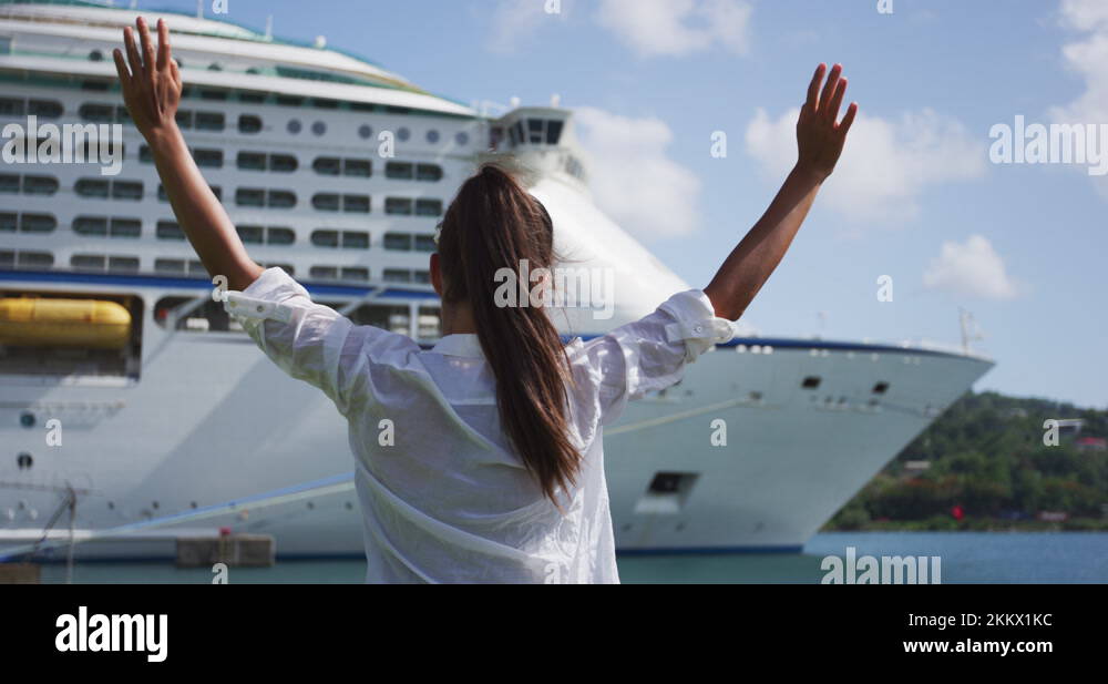 Cruise ship travel concept. Woman waving hands goodbye at cruise ship ...