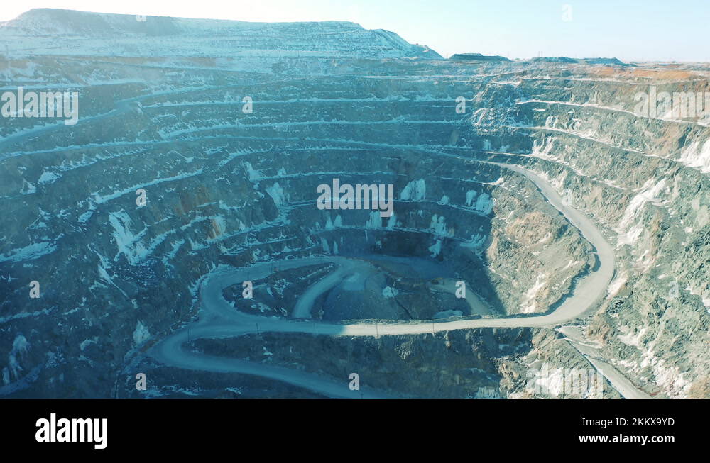 Deep open-cast mine with multiple slopes. Quarry, opencast mining, ore ...