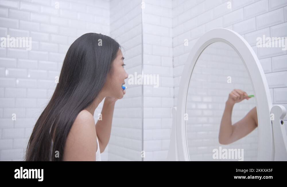 Daily routine concept of 4k Resolution. Asian woman brushing teeth in ...