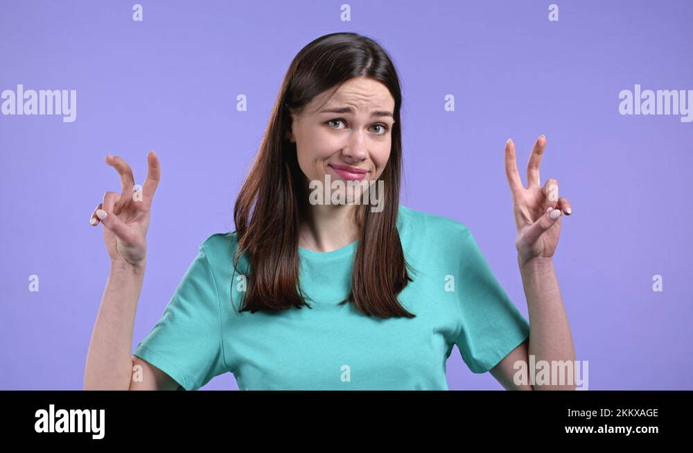 Pretty woman showing with hands and two fingers air quotes gesture ...