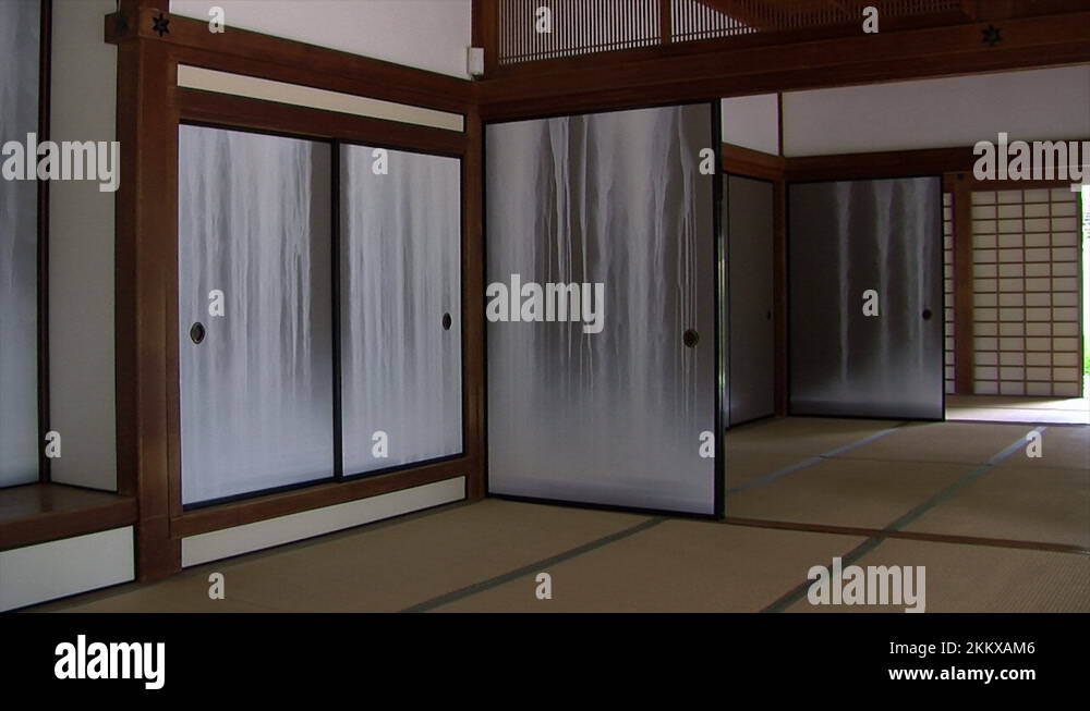 Pan of interior of Japanese house with painted fusuma to view of garden ...