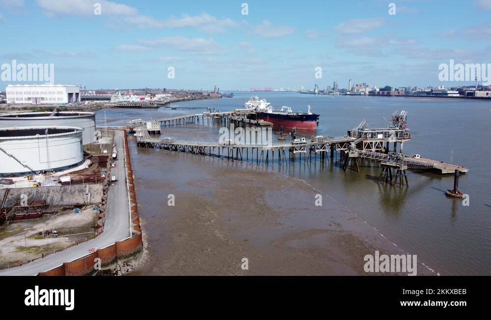 Crude oil tanker ship loading at petrochemical refinery harbour ...