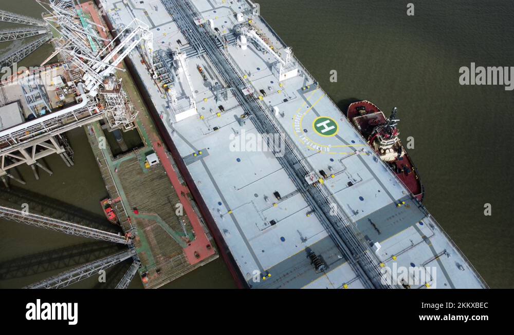Crude oil tanker ship loading at refinery harbour terminal aerial birds ...