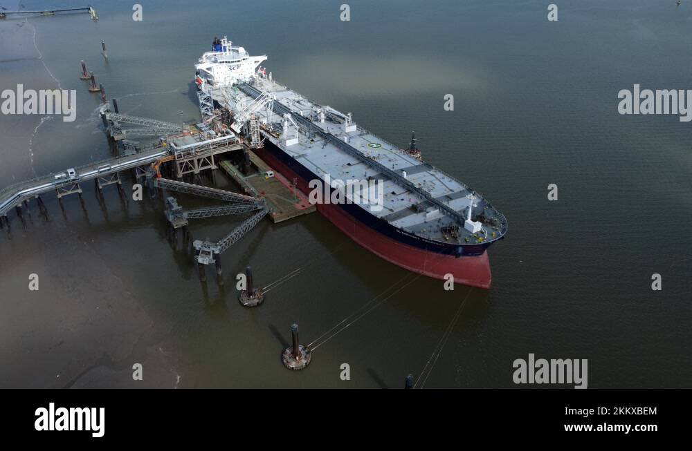 Crude oil tanker ship loading at refinery harbour terminal aerial view ...