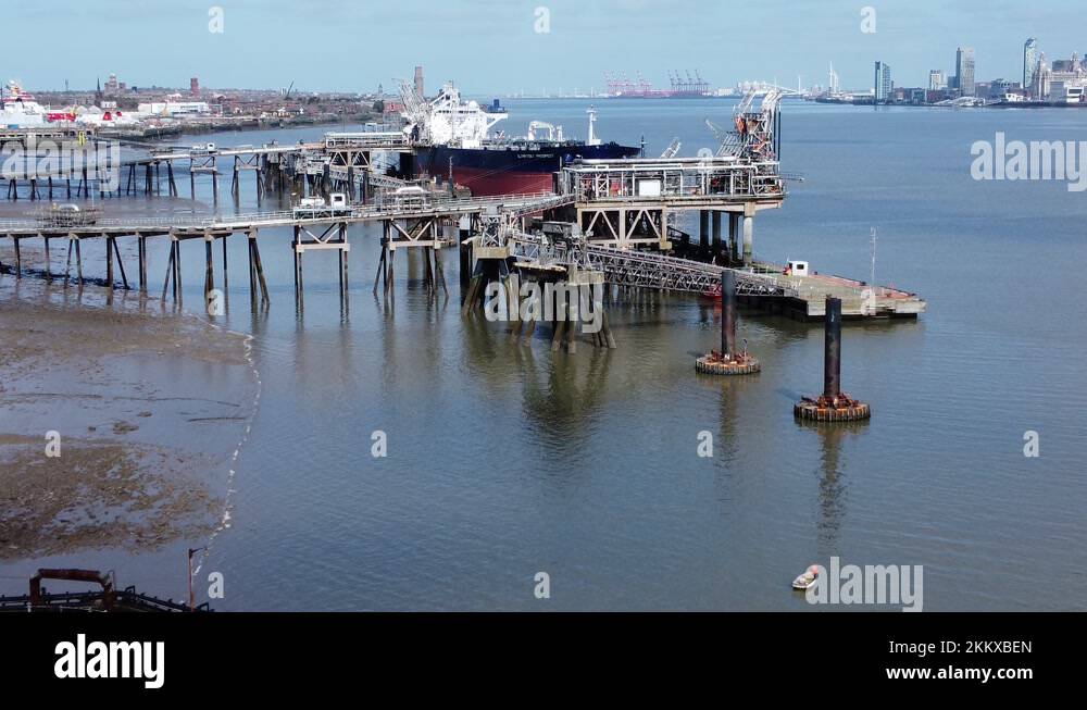 Crude oil freight tanker ship loading at refinery harbour terminal ...