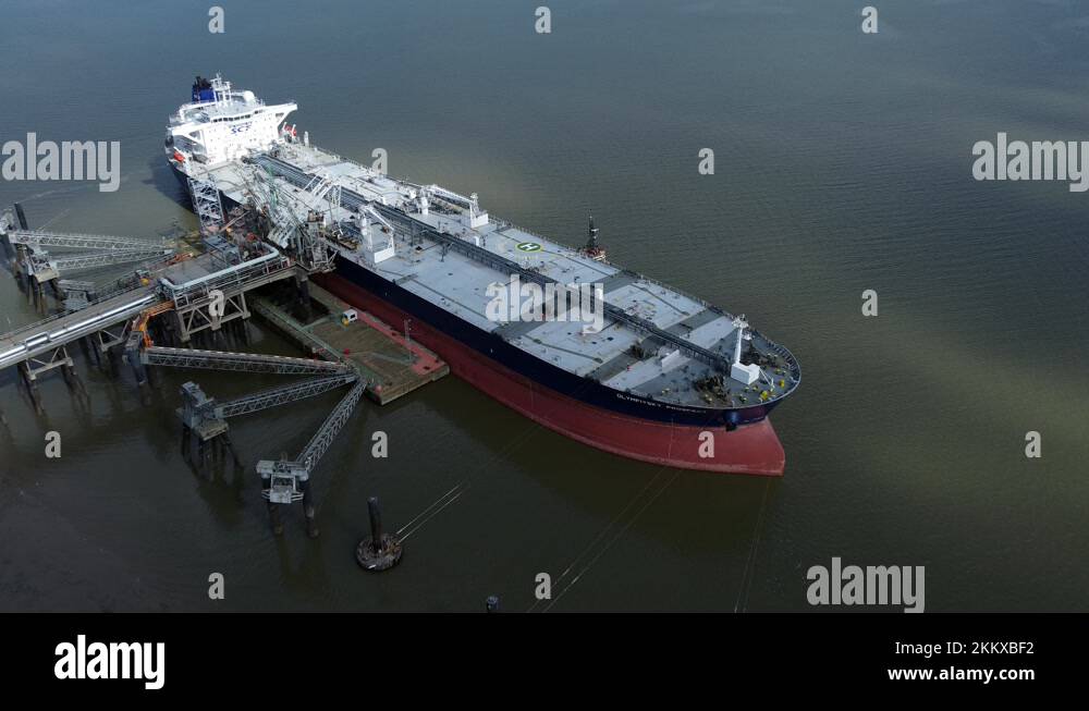 Crude oil tanker ship loading at refinery harbour terminal aerial view ...