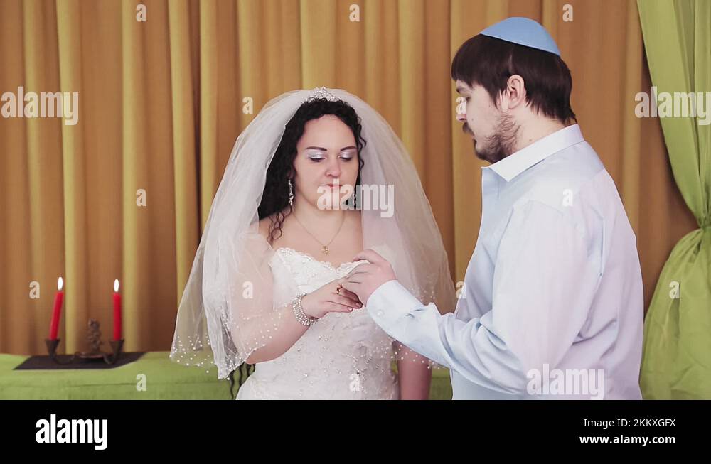 During the chuppah ceremony, a Jewish bride and groom in a synagogue ...