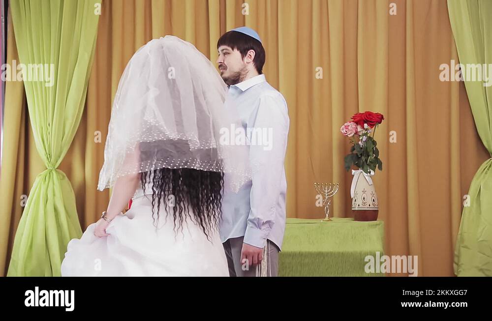 During the chuppah ceremony, the Jewish bride and groom in the ...