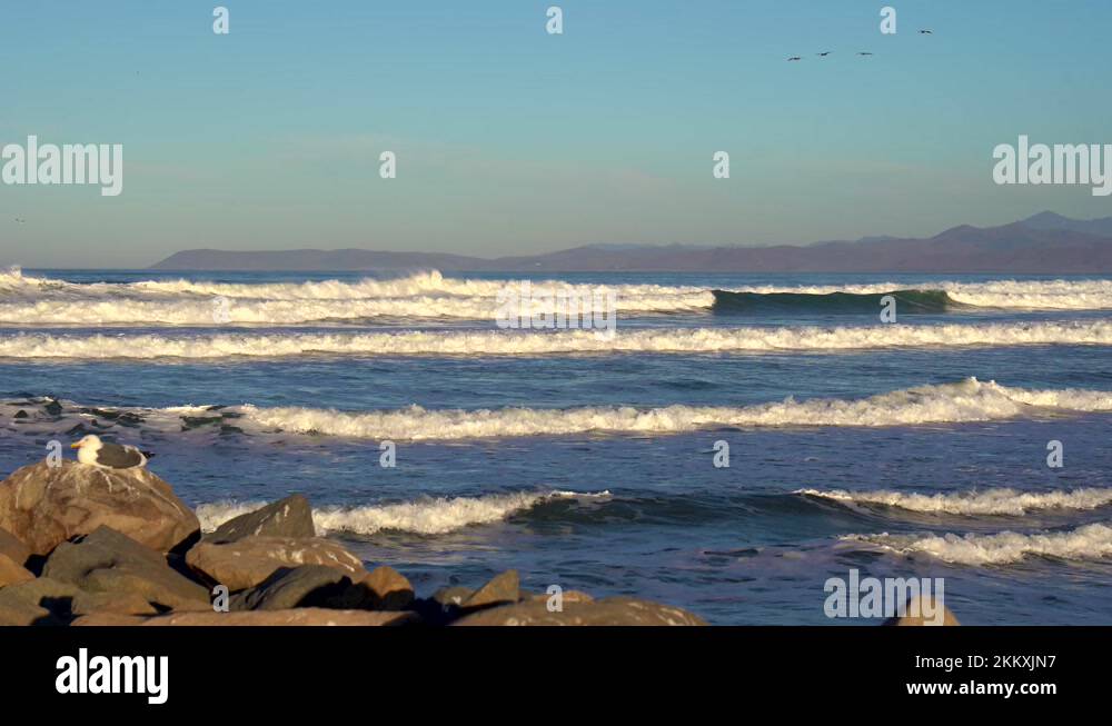 Layers of waves breaking and rolling inshore along coast during ...