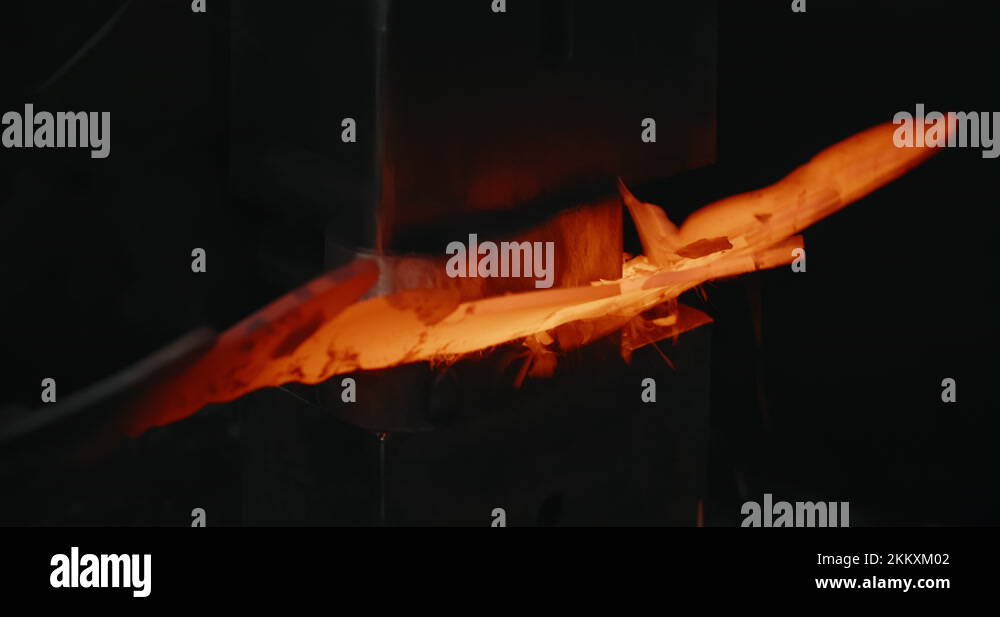 Blacksmith makes a grooved surface for decorative red-hot forged metal ...