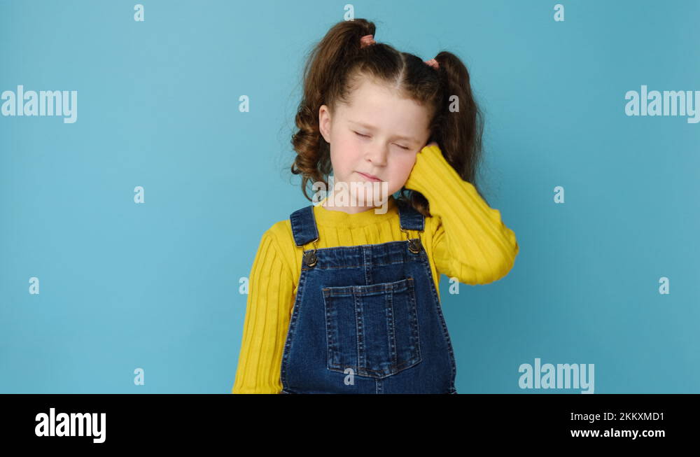 Frowning little girl kid touch ear, hurt suffers from earache strong ...