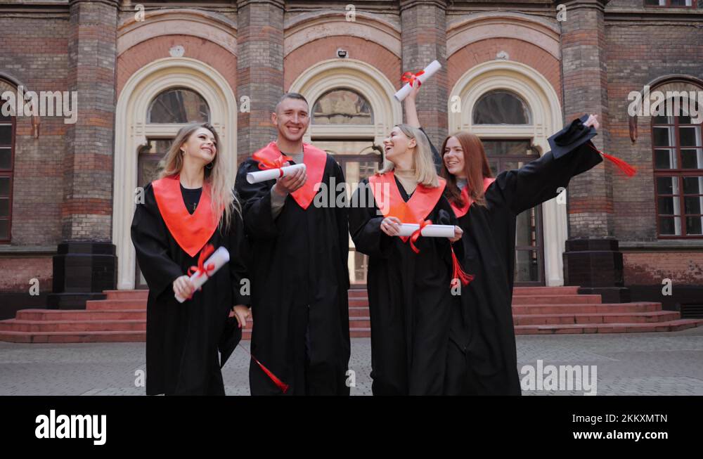 Graduates in gowns certificates with honors go to celebrate graduation ...