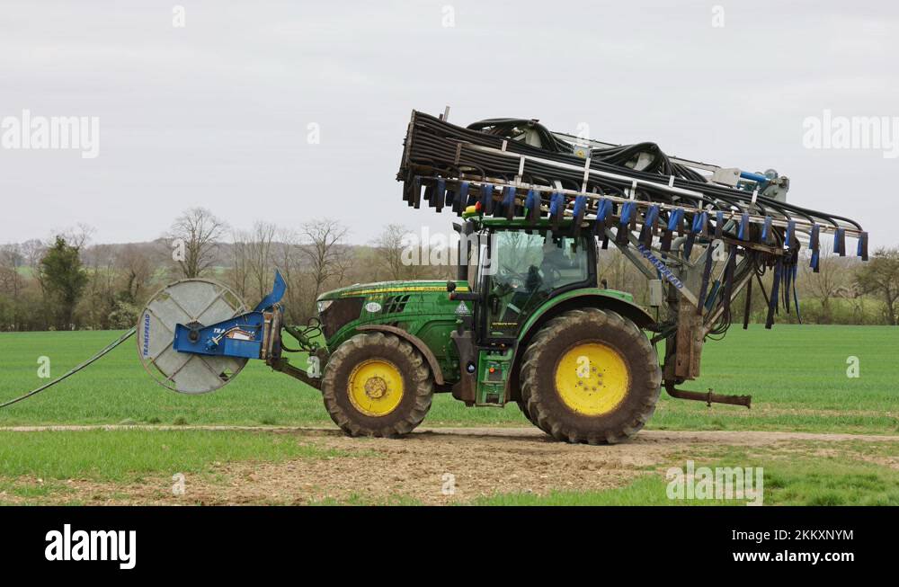 Tractor fitted with a folded slurry spreader Dribble Bar and hose ...