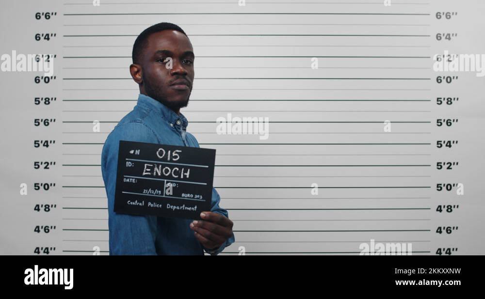 Mugshot of male afro american criminal getting photographed at police ...