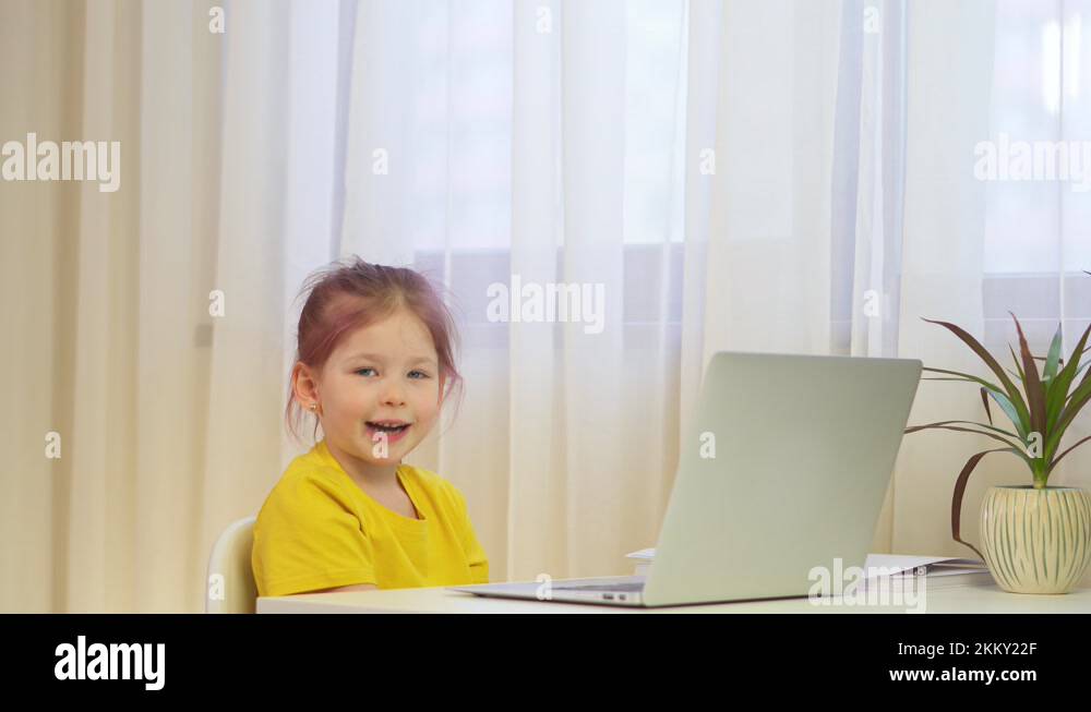 Little girl is talking looking into the camera. The child works use ...