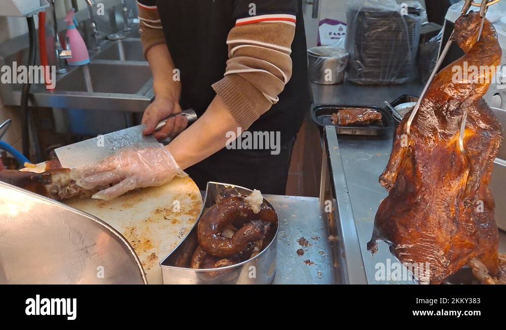 Chinese food: cook cutting roast goose in a Cantonese restaurant Stock ...