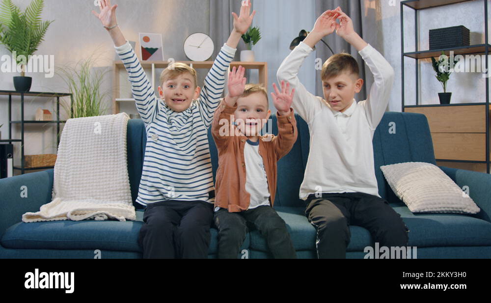 Handsome smiling happy different ages three brothers sitting on the ...