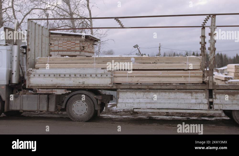 Forklift load stack of lumber planks on motor lorry at sawmill factory ...