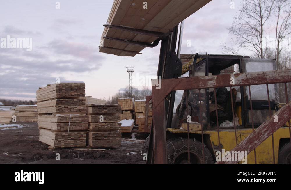 Forklift load packs of timber boards on wagon lorry at sawmill factory ...
