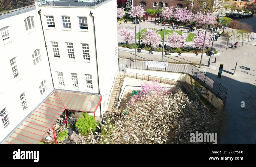 school kids in the school compound tilt down reveal in the city centre ...