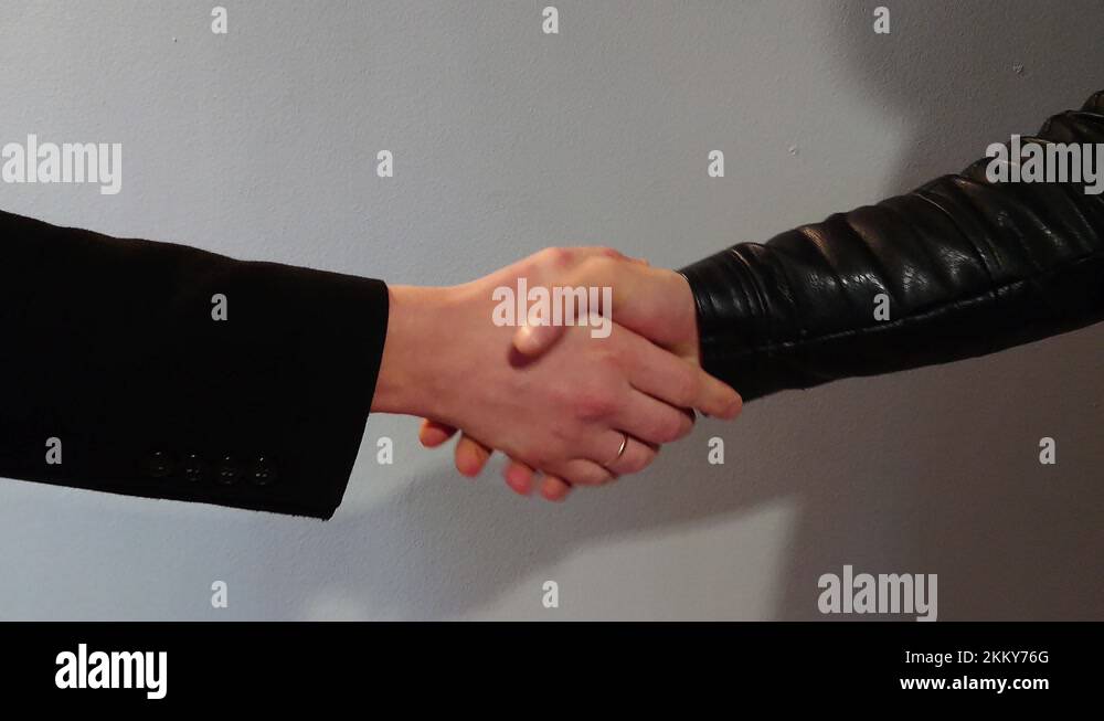 two men in black shake hands, make a deal, say hello, say goodbye Stock ...