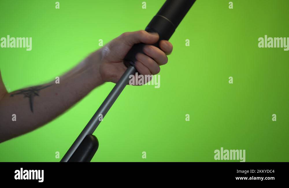Mounting a silencer on a single barrel shotgun weapon on green screen ...