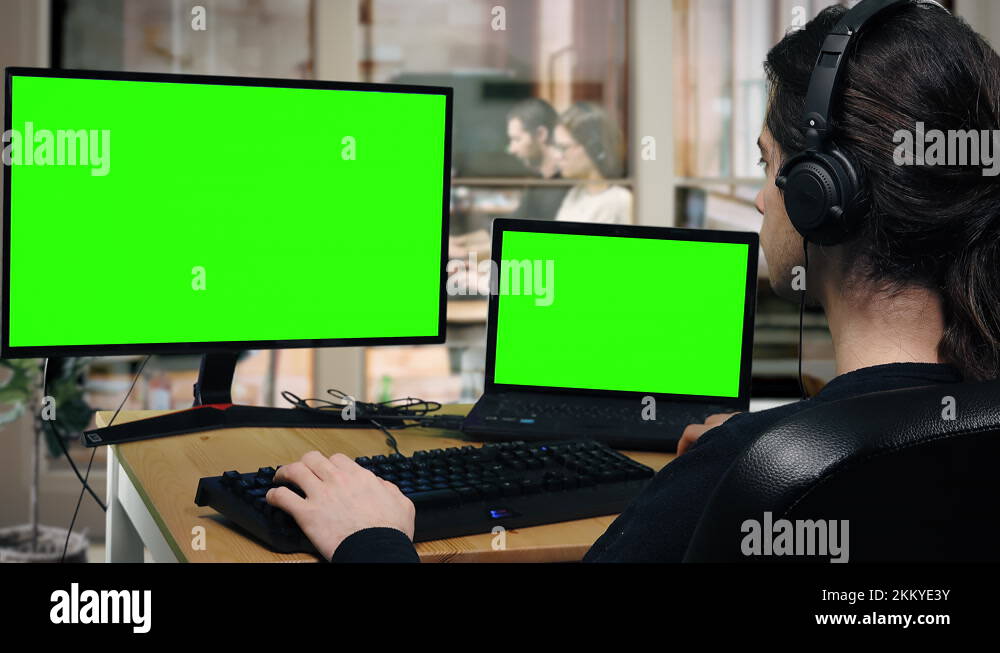 Working On Multiscreen Computers Inside Office With Coworkers, Green ...