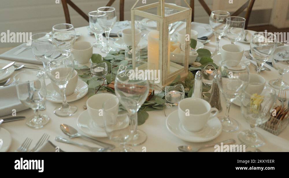 Orbit of a beautiful white wedding reception table décor set up at the ...