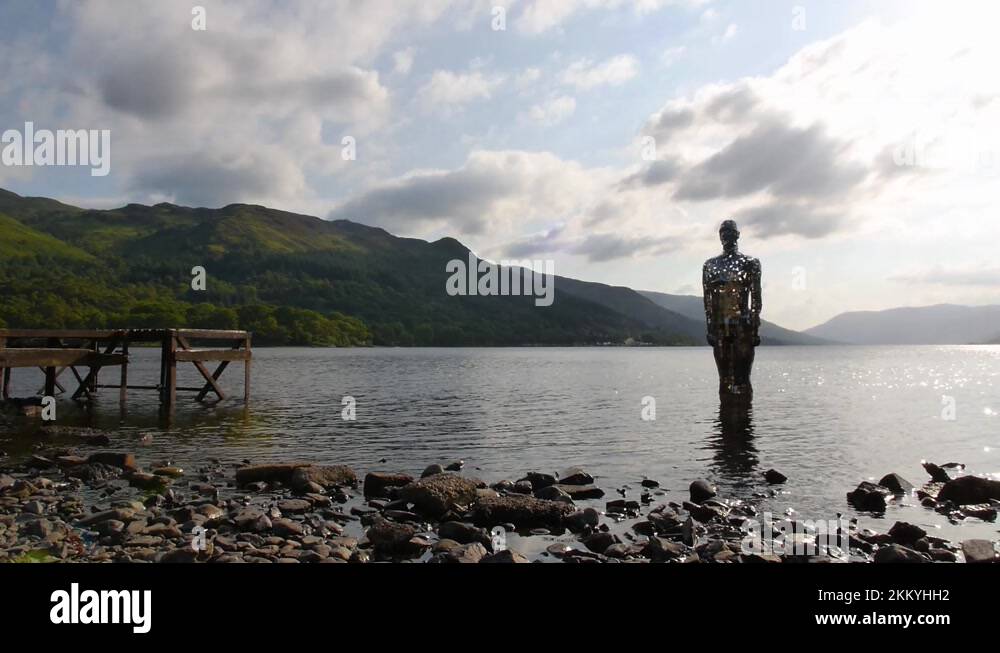 Pan left to right looking across Loch Earn with 'The Silver Man' art ...