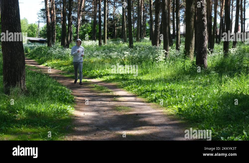 Single young man running in the forest park, street workout. Fitness ...