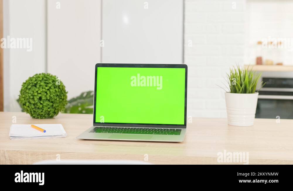 Modern laptop with mock up chroma key green screen on table of living ...