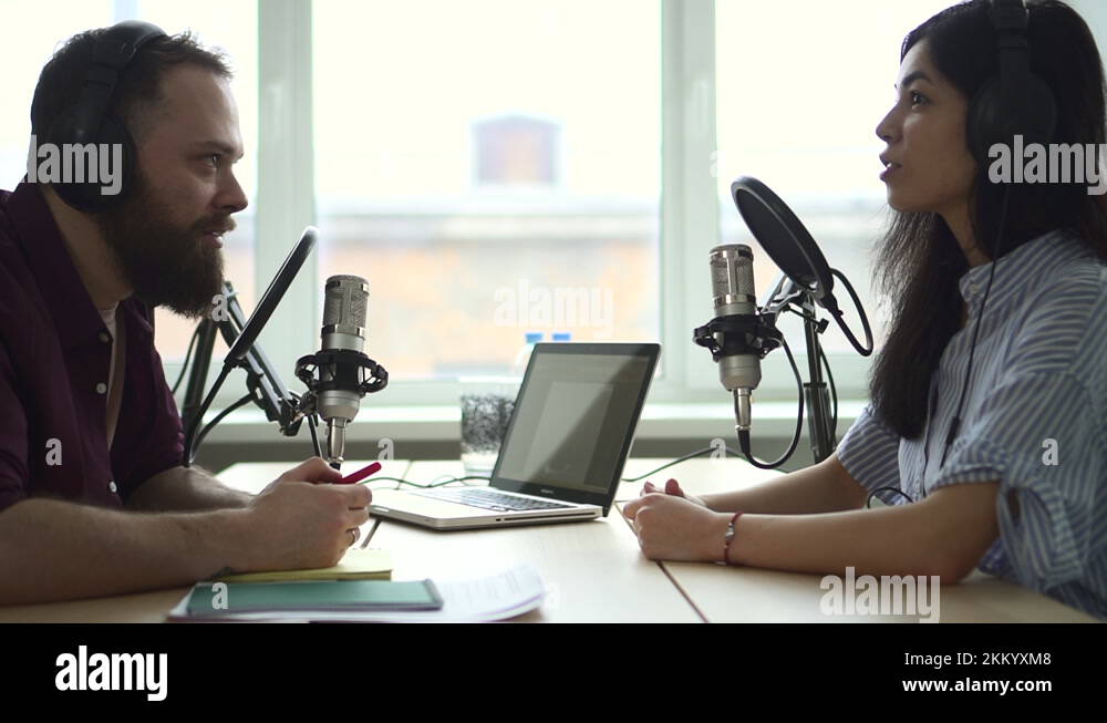 Colleagues radio host discuss news together and record radio, sit at ...