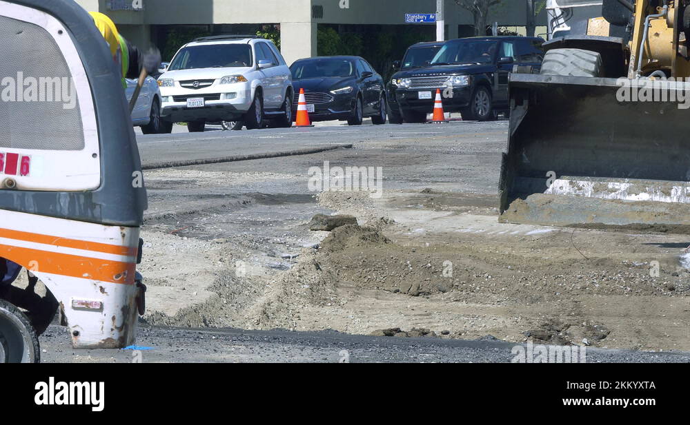 Excavator and road scraping machine removes old asphalt during road ...