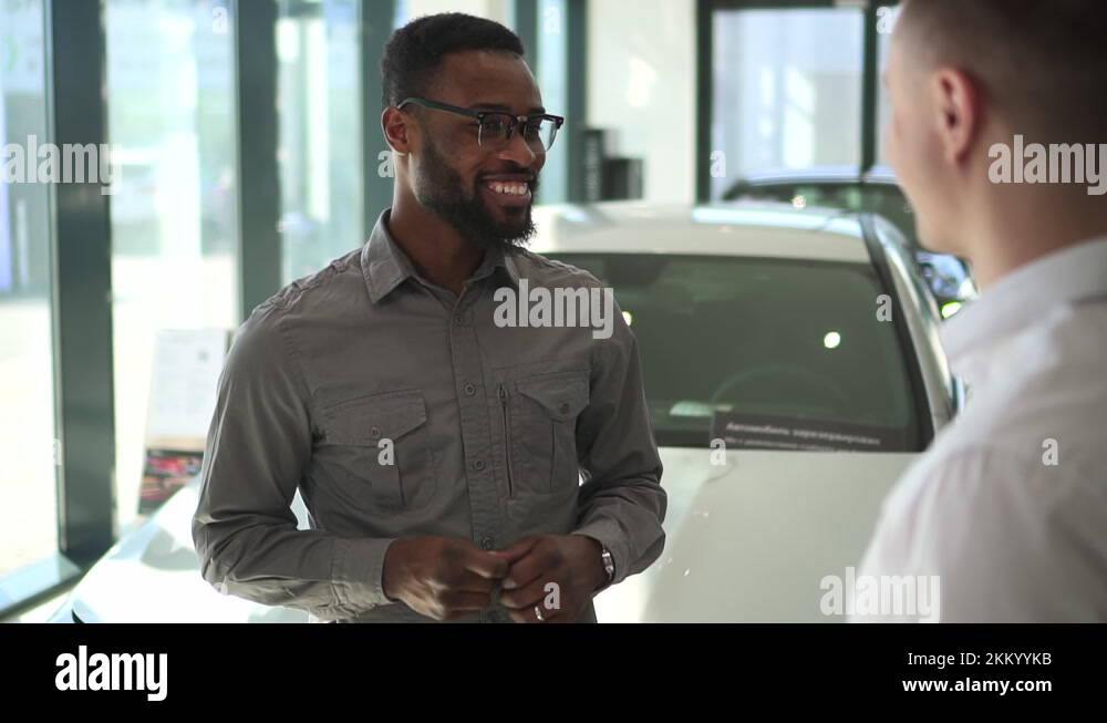 Buy car, agent give key to new rental auto owner in dealership store ...