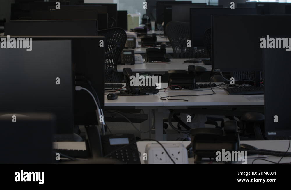 Rows Of Empty Desks And Workstations In Unoccupied Office. Tilt Up ...