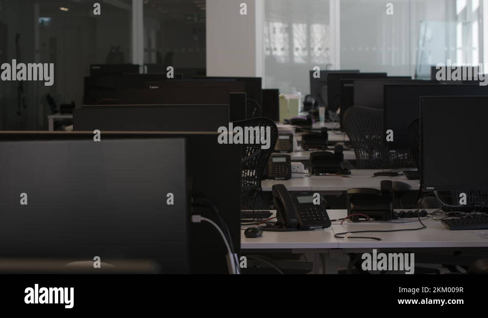 Rows Of Empty Desks And Workstations In Unoccupied Office. Pan Right ...