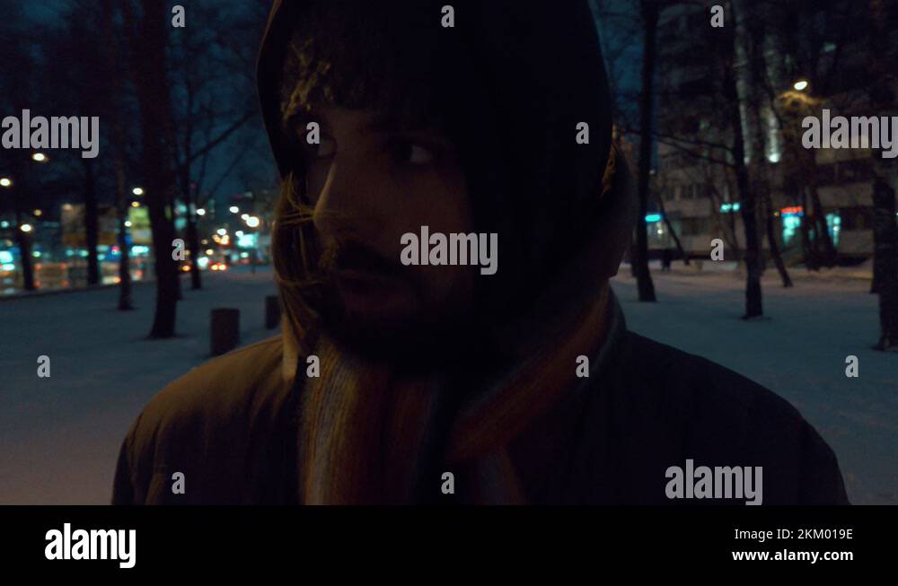 Moody scene of Man walking on dark cold winter streets in frozen Russia ...