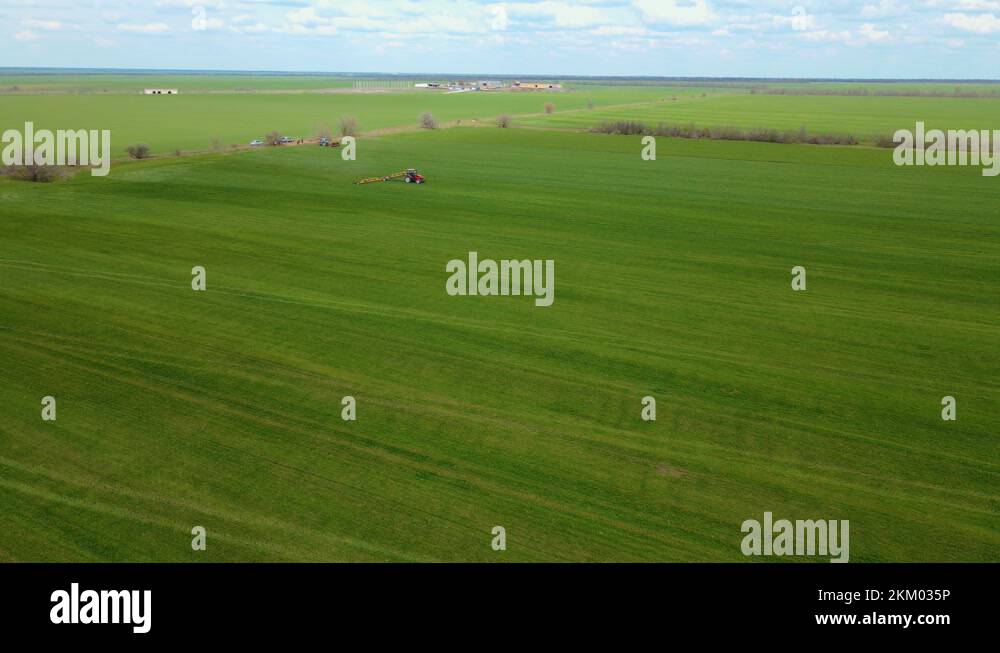 People forks on agronomic field using heavy machinery and tractors with ...