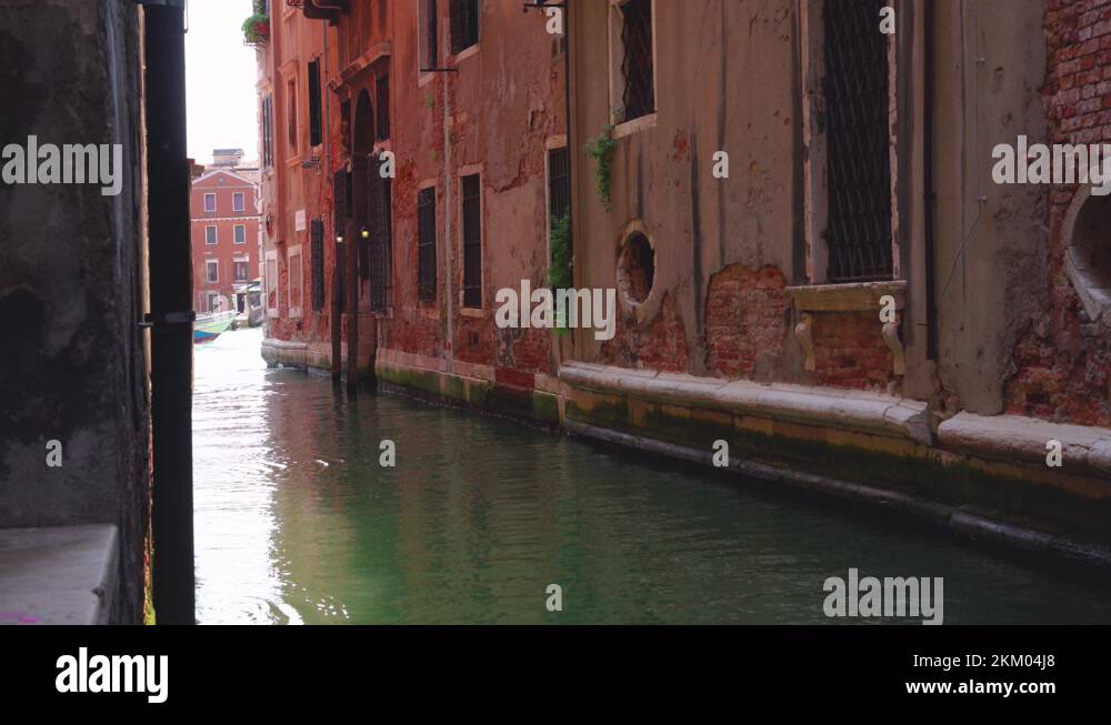 Venice - Quiet side canal with circular windows, exposed bricks ...