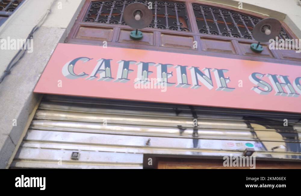 Caffeine Shop Facade With Pink Sign Banner. low angle, panning right ...