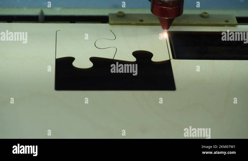 Automatic wooden jigsaw puzzle production on toys factory. 4k macro hdr ...