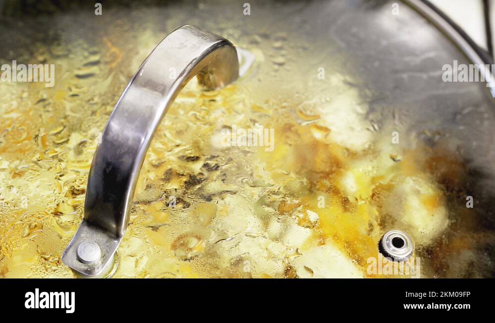 cooking in the kitchen steam comes out of the pan from boiling ...